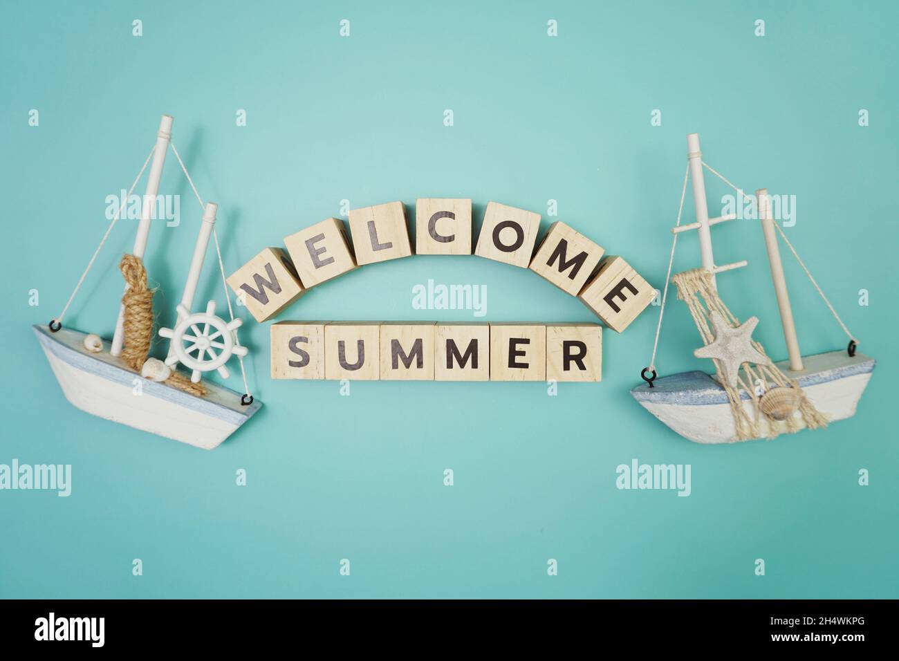 Welcome Summer message alphabet letter with sailboat on blue background ...
