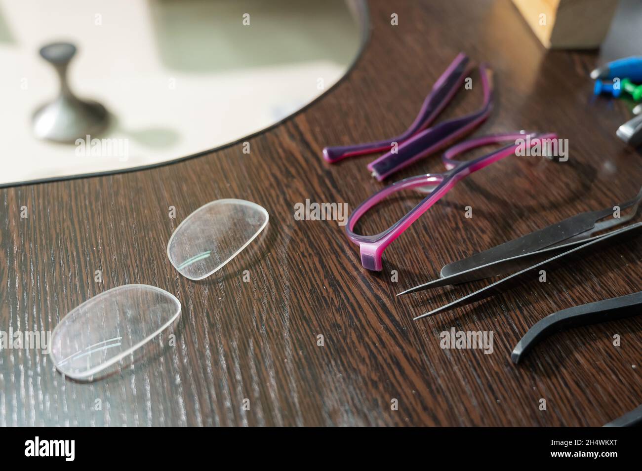 Optical technician work table. Close-up of lens frames and screwdrivers ...