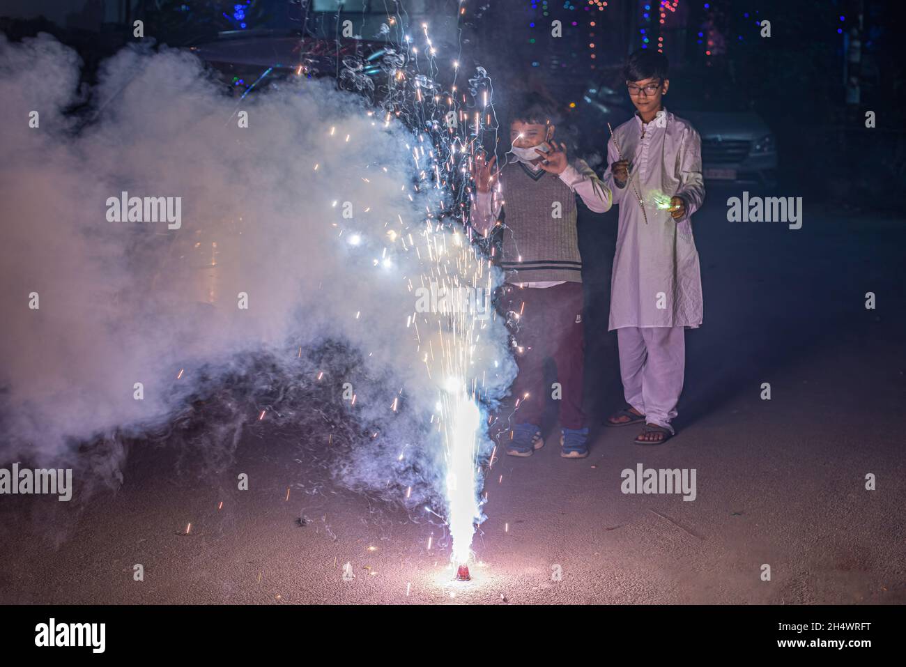 Indian boys play with a fountain firework during the Diwali festival ...