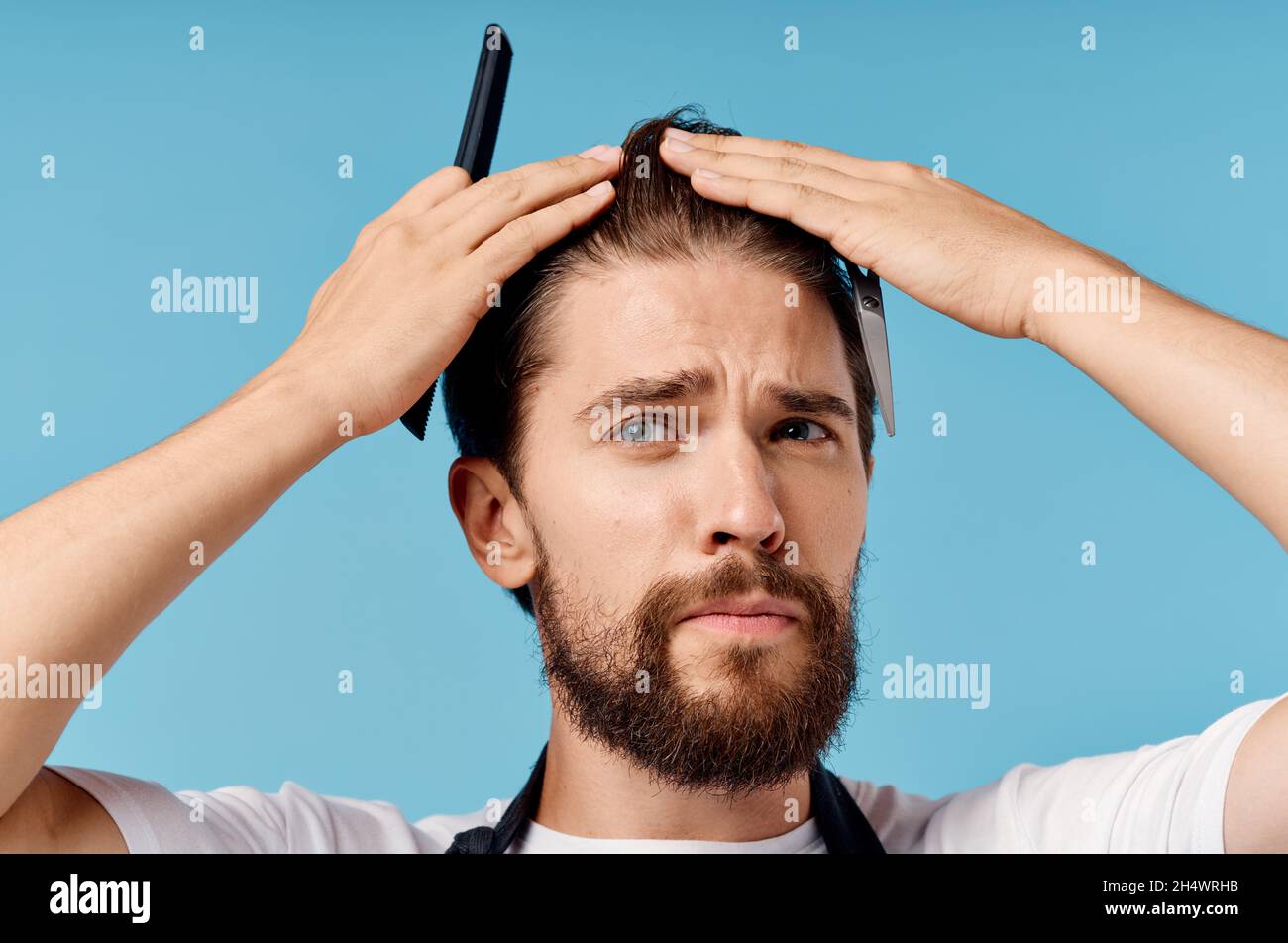 male hairdresser modern hairstyle blue background Stock Photo - Alamy
