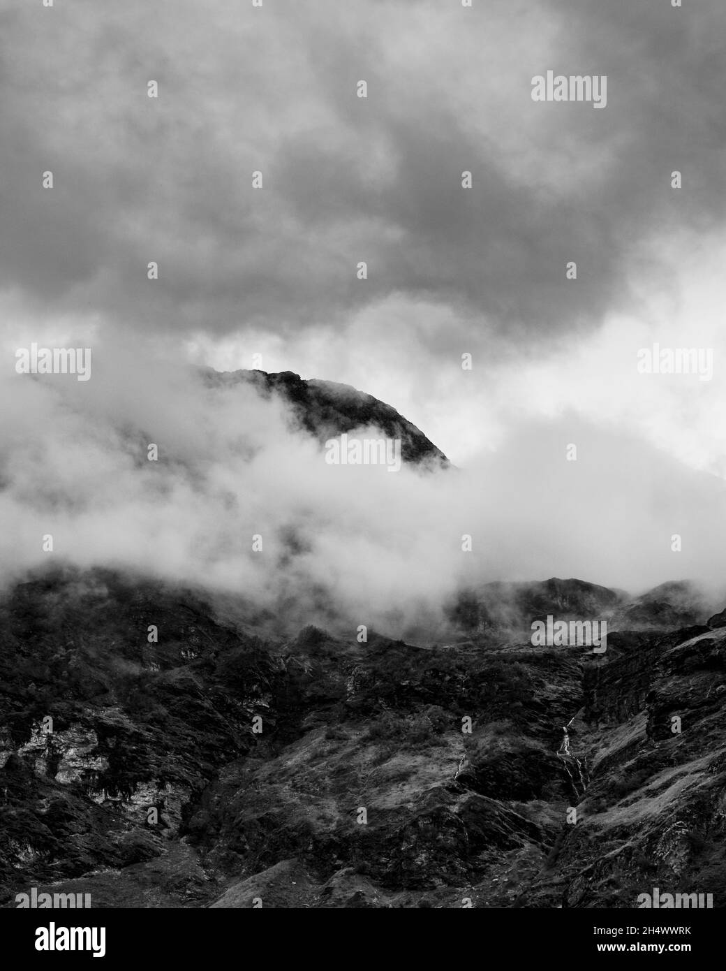 Cloud over moutain peak Stock Photo - Alamy