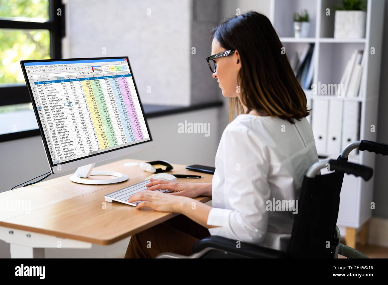 Business Woman With Disabilities In Wheelchair Using Computer Stock ...
