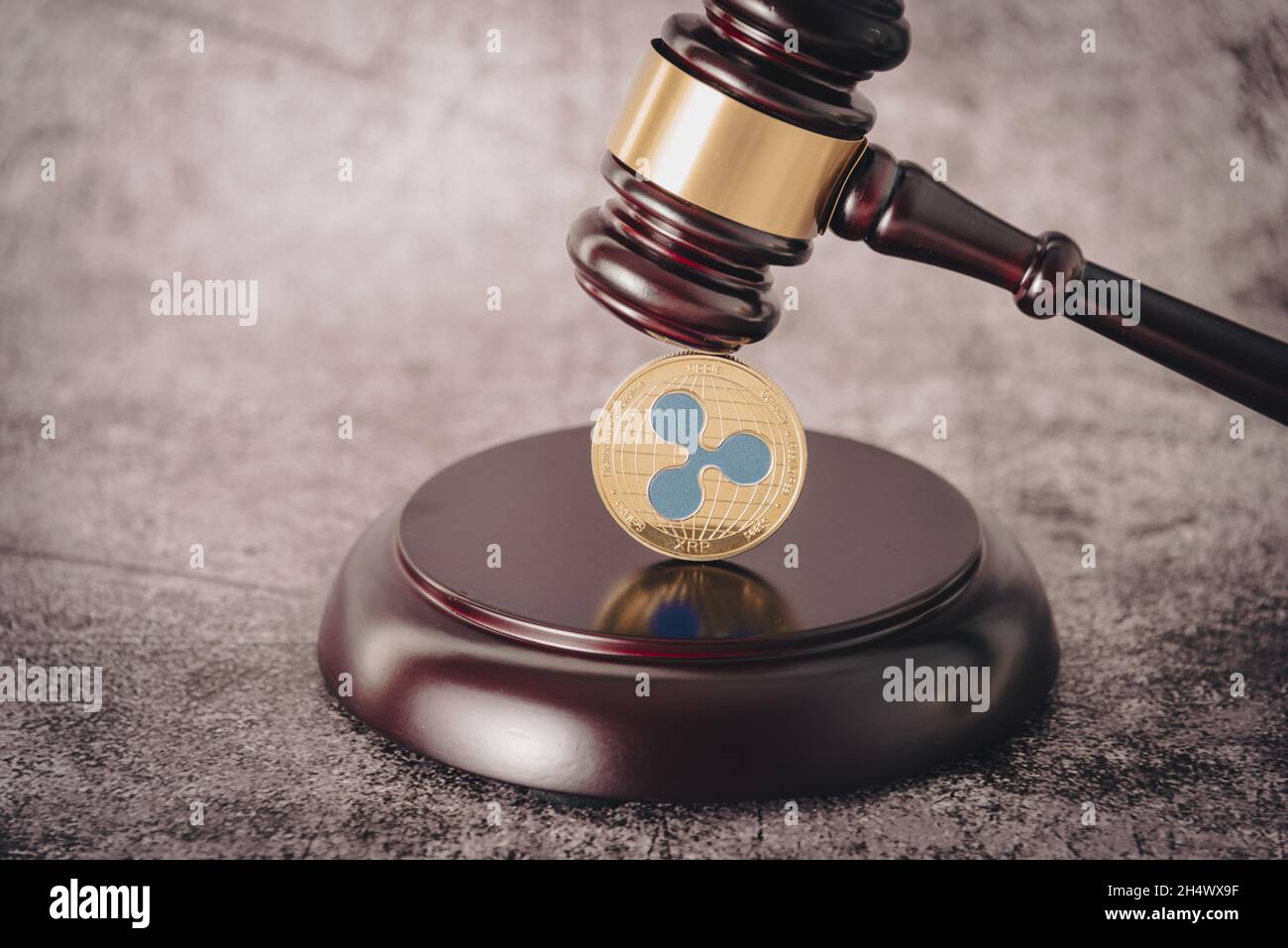 Judge's gavel holding a descriptive cryptocurrency coin Stock Photo - Alamy