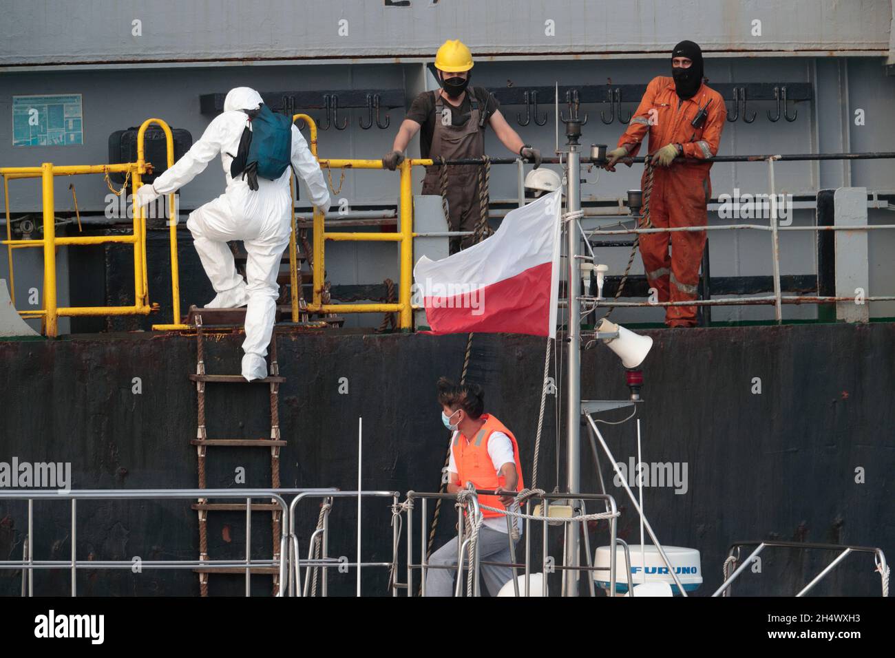 Hong Kong Harbour Pilot in full hazmat suit goes aboard arriving vessel ...