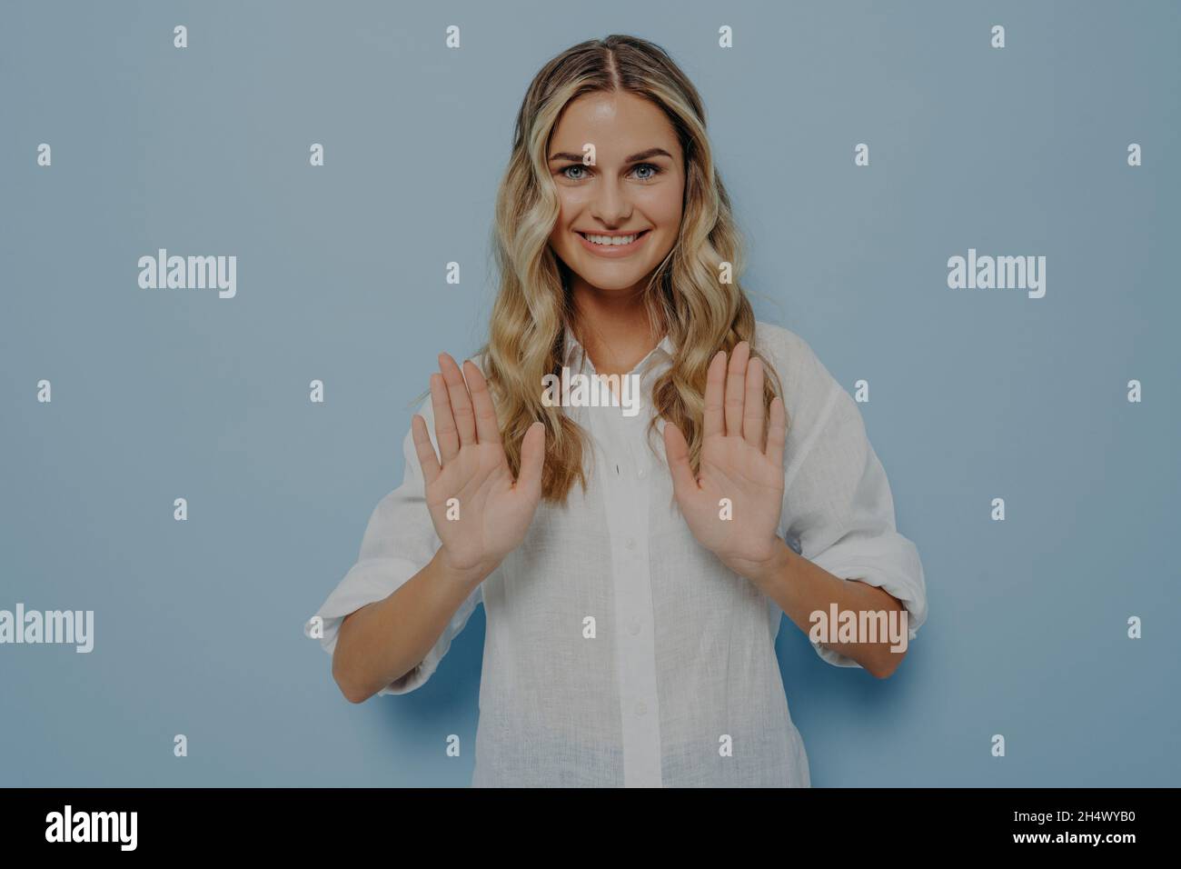 Blonde teenage girl politely refusing Stock Photo - Alamy