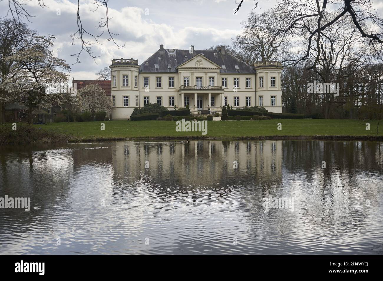 Historic Buldern Castle reflected in the river water on a gloomy day in ...