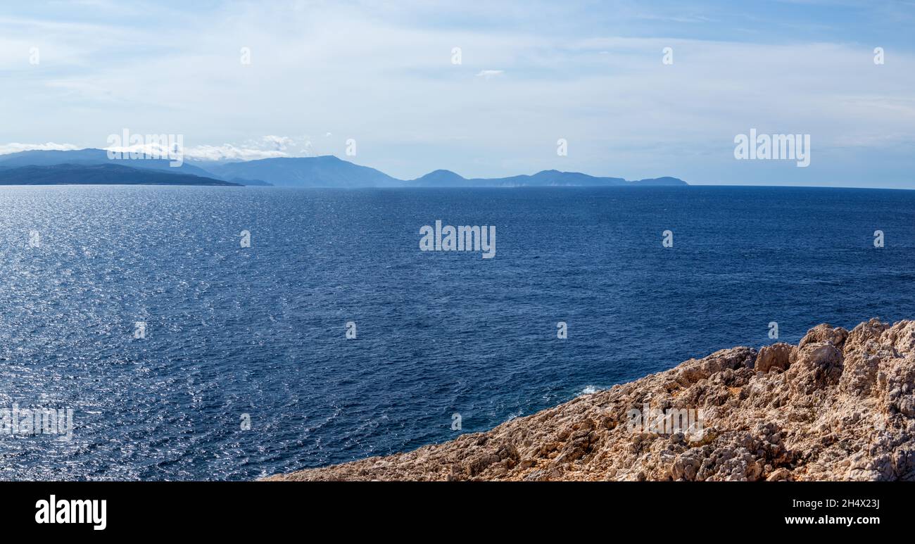 Rocky steep cliff close-up on blue vivid Ionian seascape view with ...