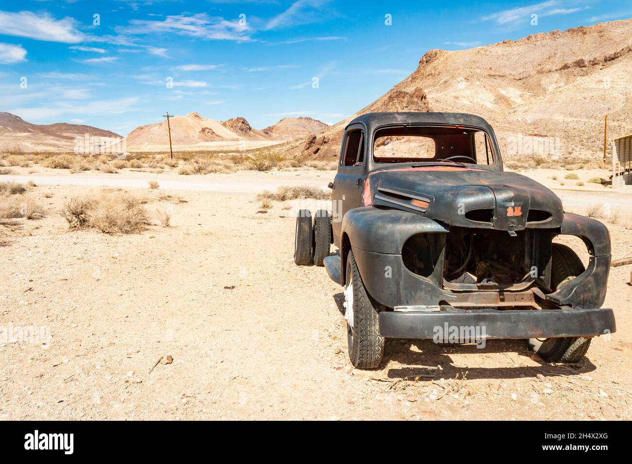 abandoned truck wreck in ghost town of Rhyolite in desert Death Valley ...