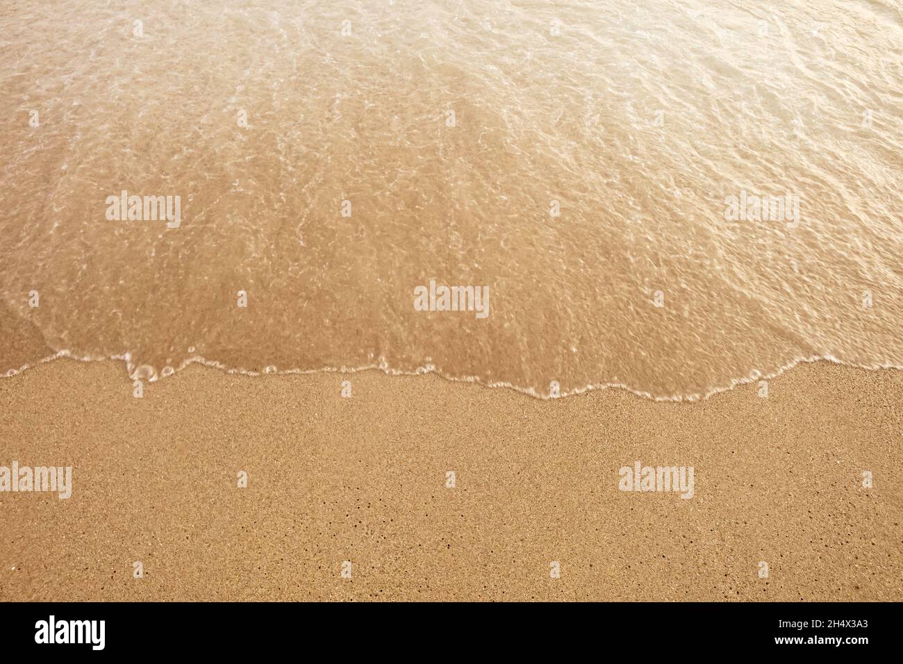 Sea sand and wave Stock Photo - Alamy