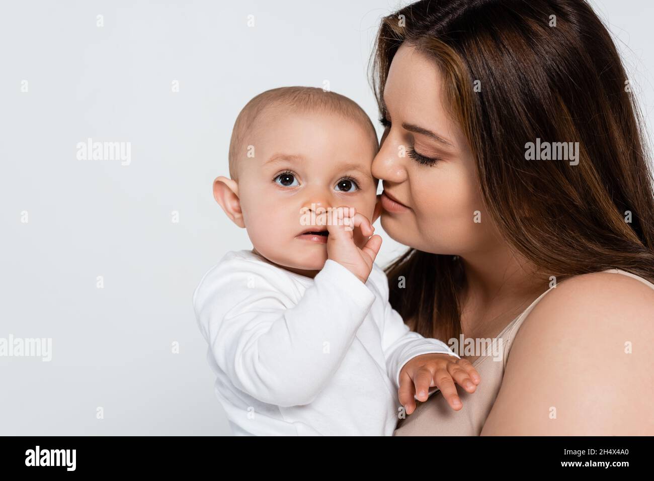 Portrait of mother with overweight looking at baby daughter isolated on ...