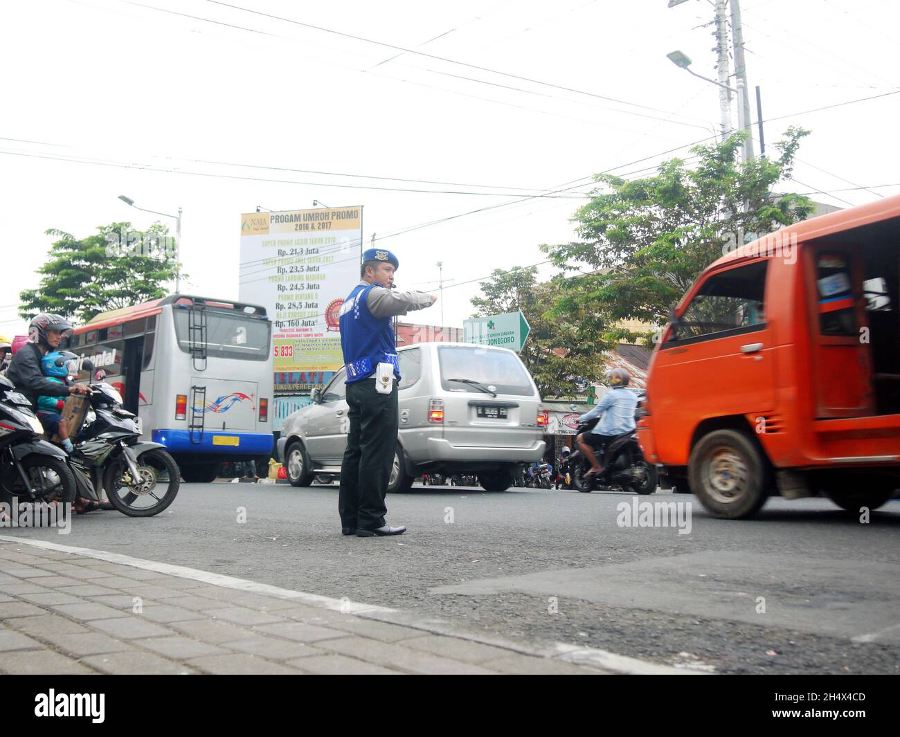 an indonesian police officer is controlling the flow of traffic Stock ...