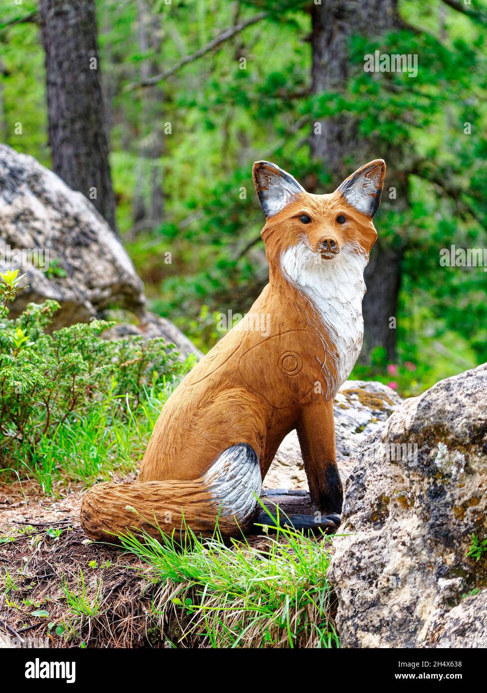 red fox wooden statue in the forest Stock Photo - Alamy