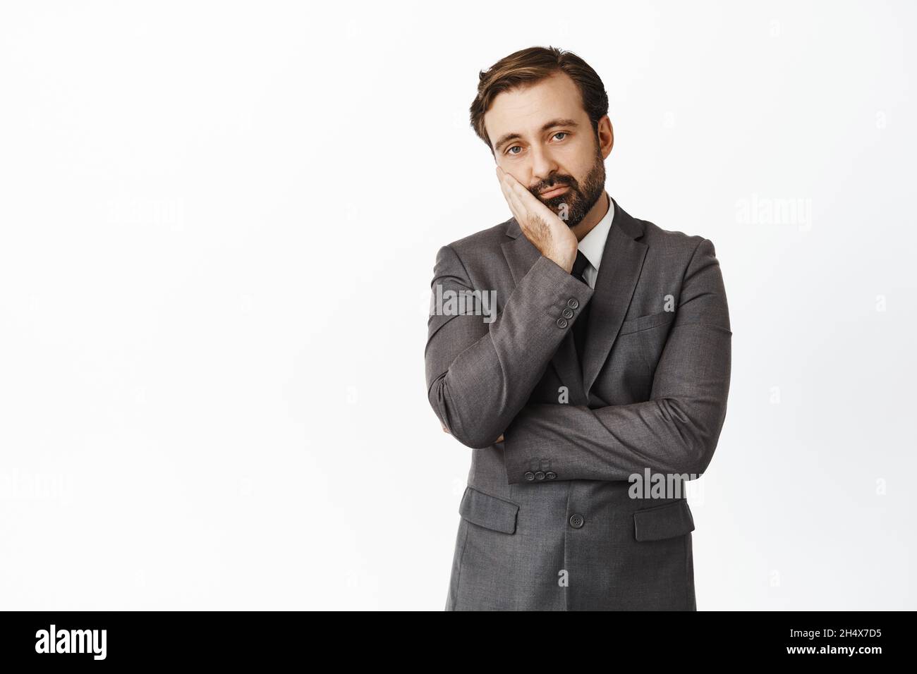 Portrait of corporate man looking sad or bored, lean head on palm and ...