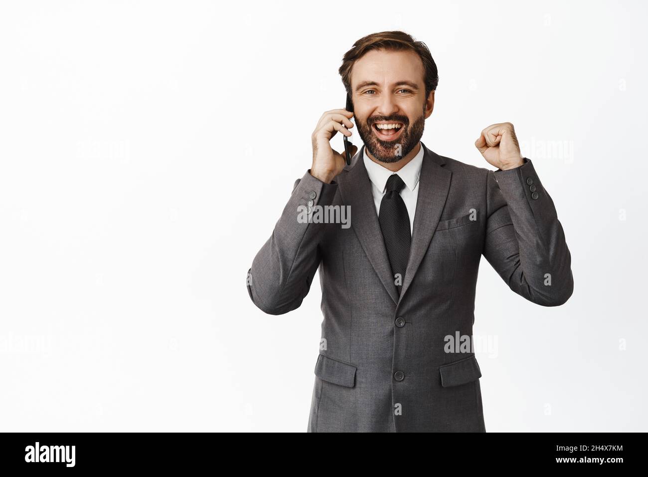 Enthusiastic businessman receive happy phone call, rejoicing from great ...