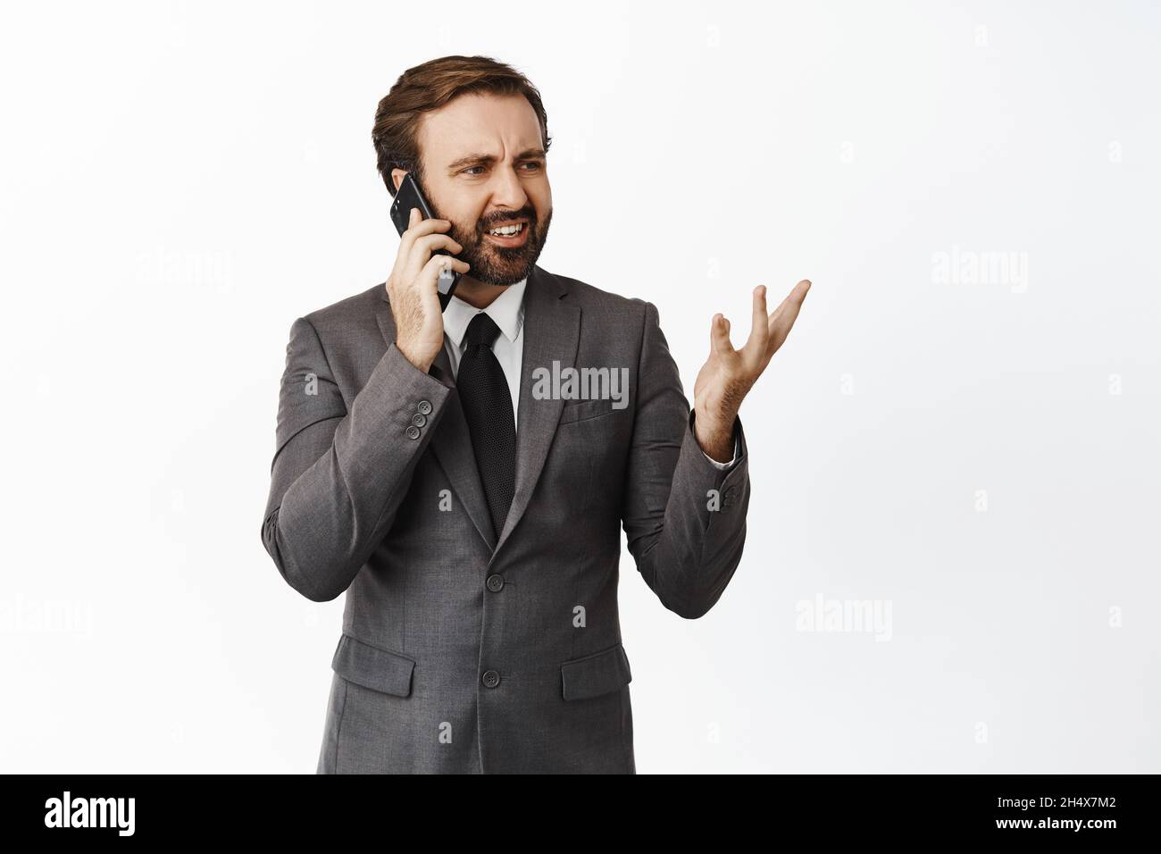 Angry corporate man arguing on cellphone, having intense phone call ...