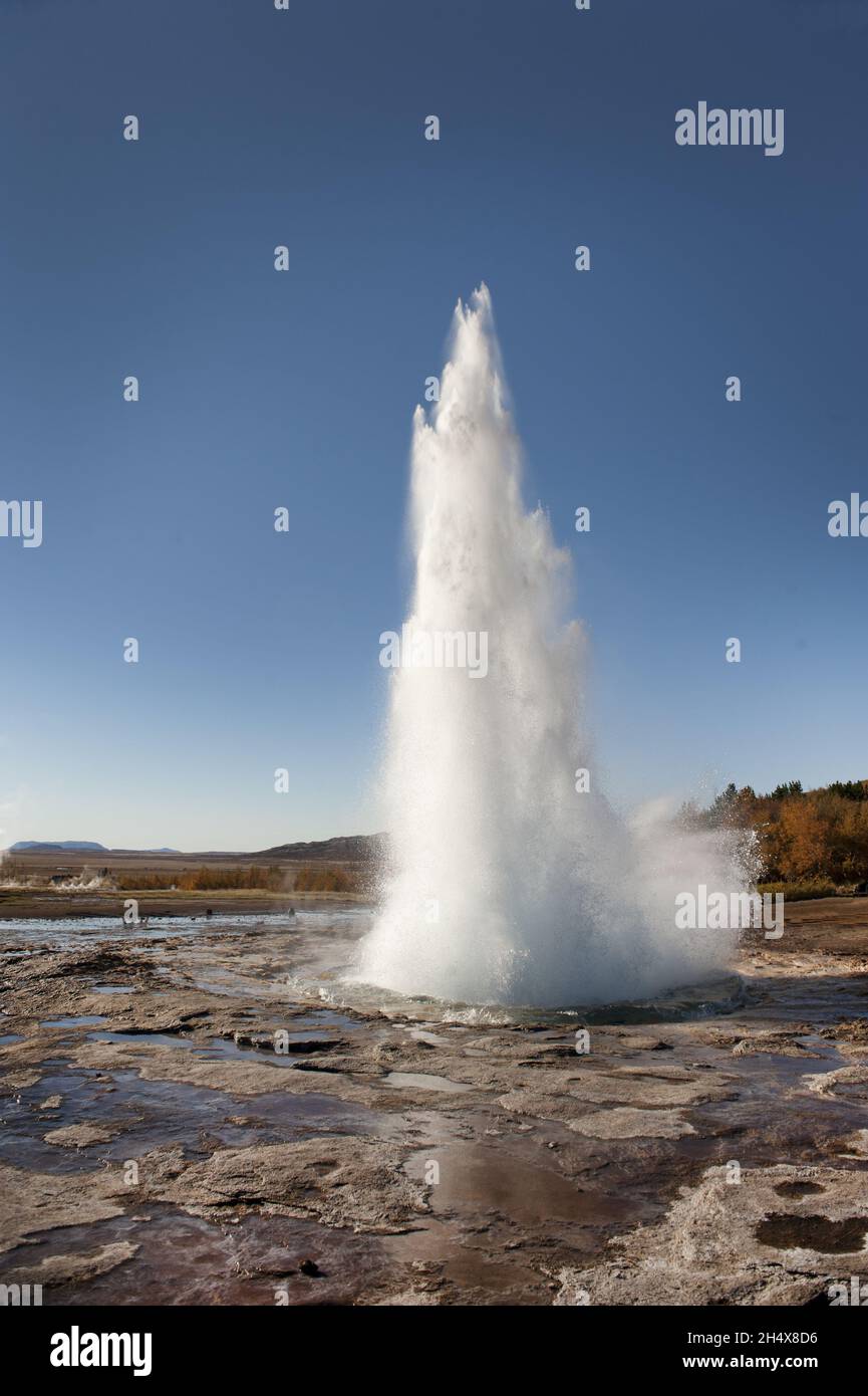 Strokkur (The Churn) geyser 100 metres south of the Great Geysir during ...