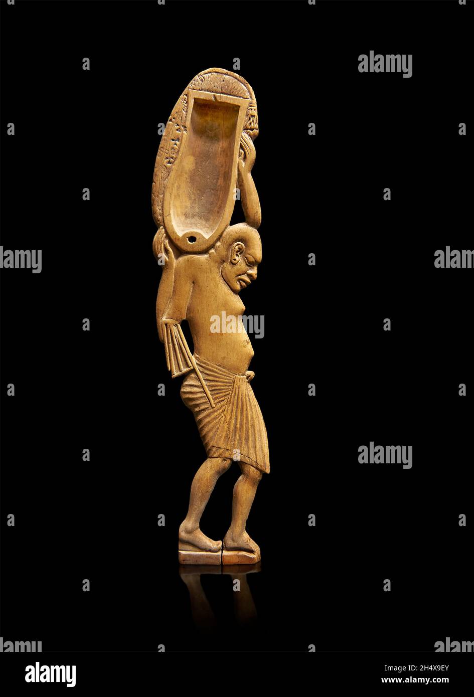 Ancient Egyptian shadow cosmetic spoon of a man carrying a container ...