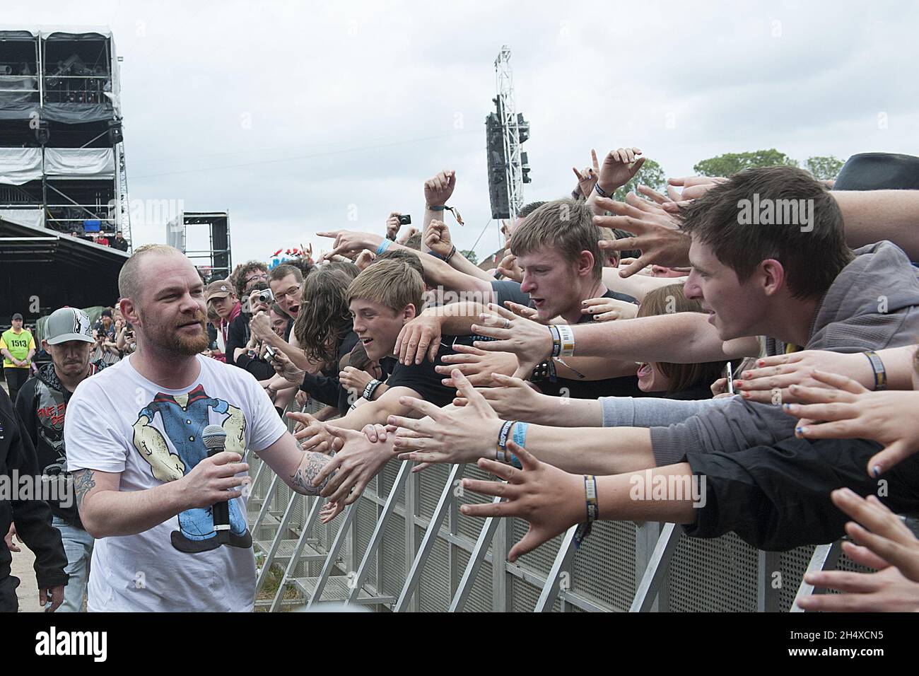 Ivan L. Moody of Five Finger Death Punch going in the crowd at concert ...