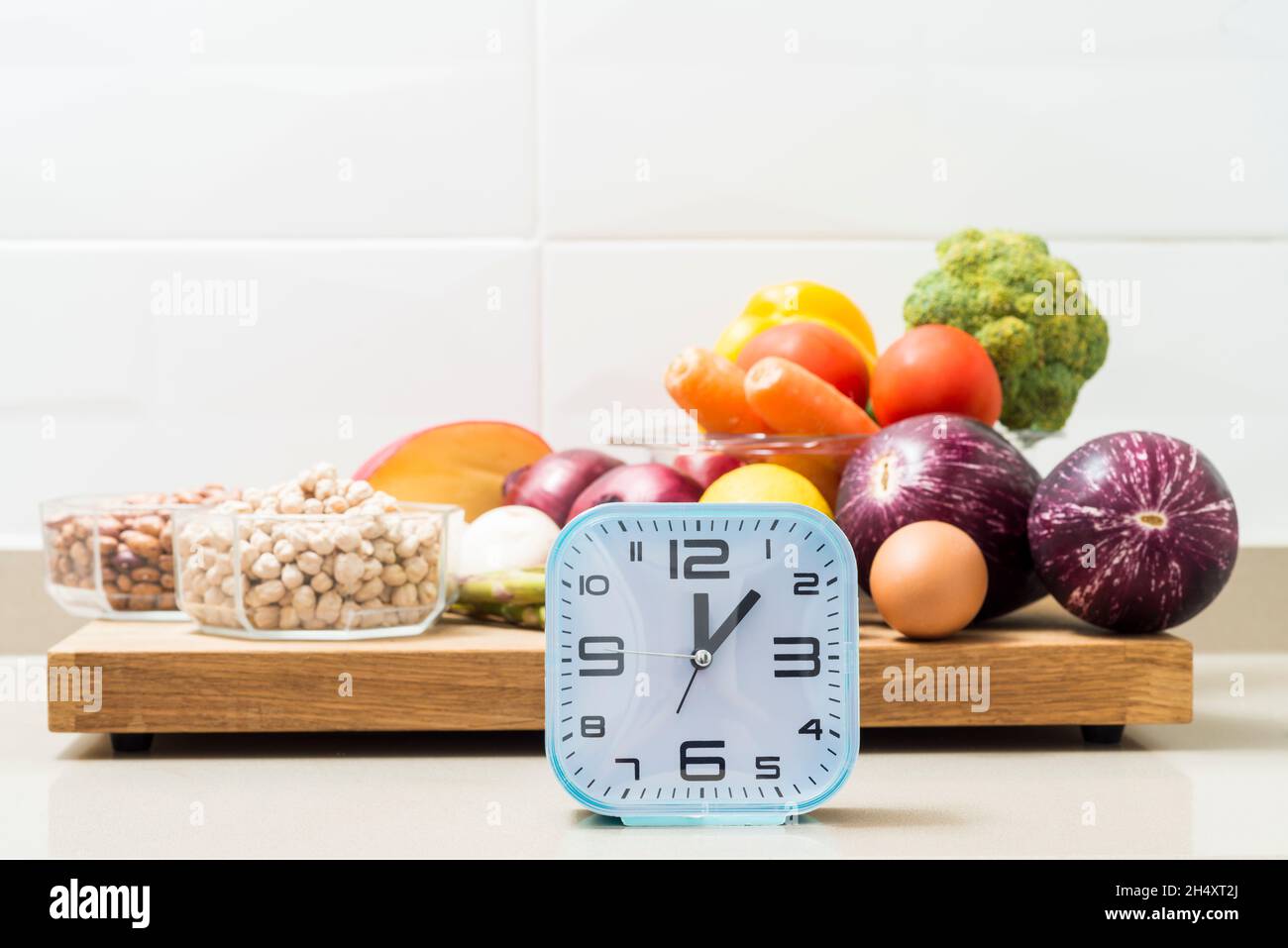 Still life with a clock and healthy food. Conceptual image of ...