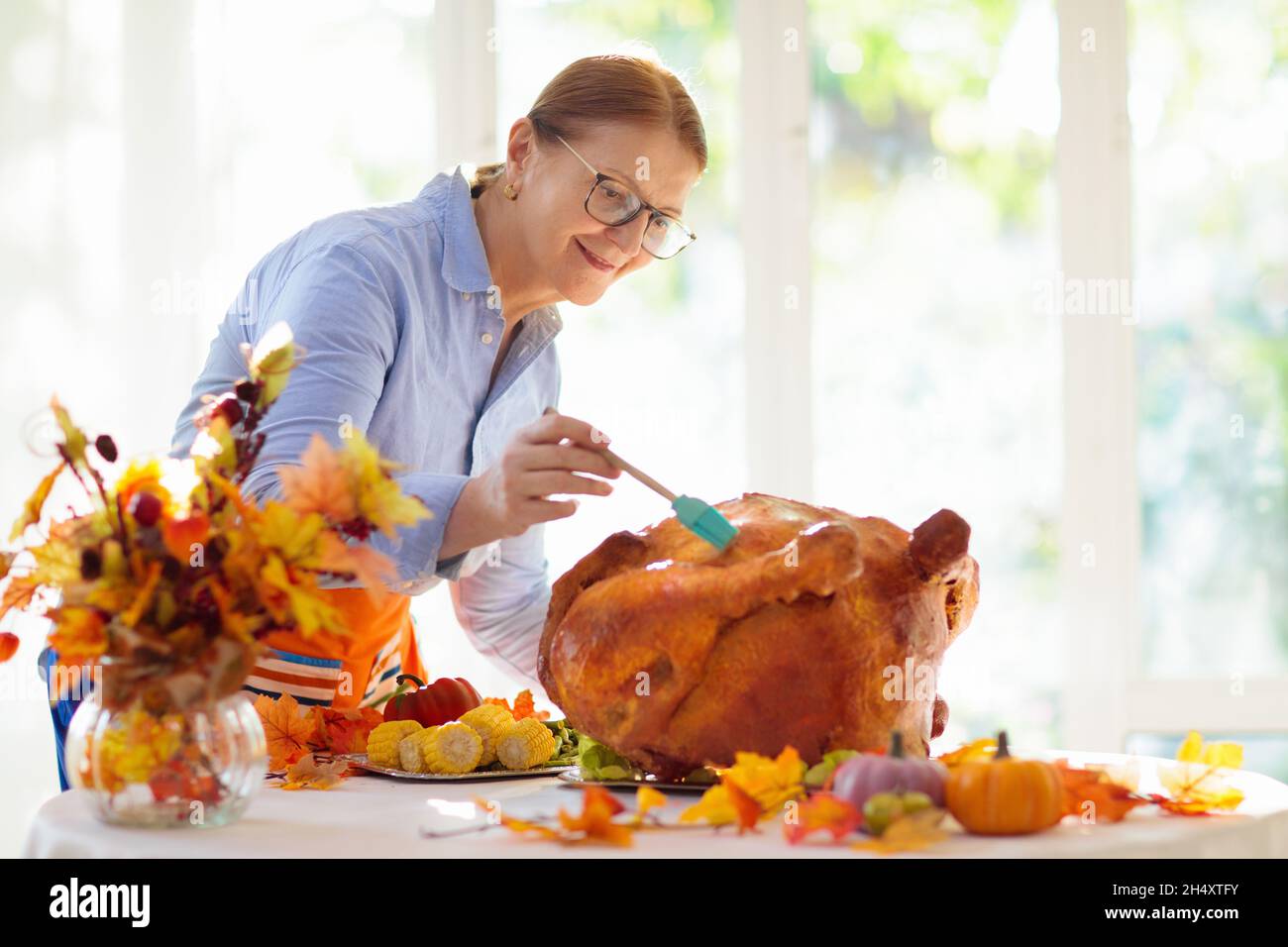 Turkey for Thanksgiving. Family cooking festive dinner. Grandmother and ...