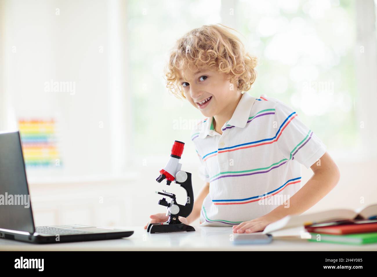 School kids with microscope. Science class. Children making biology or ...