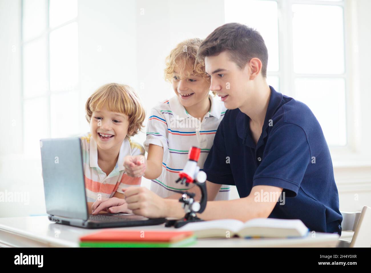 School kids with microscope. Science class. Children making biology or ...