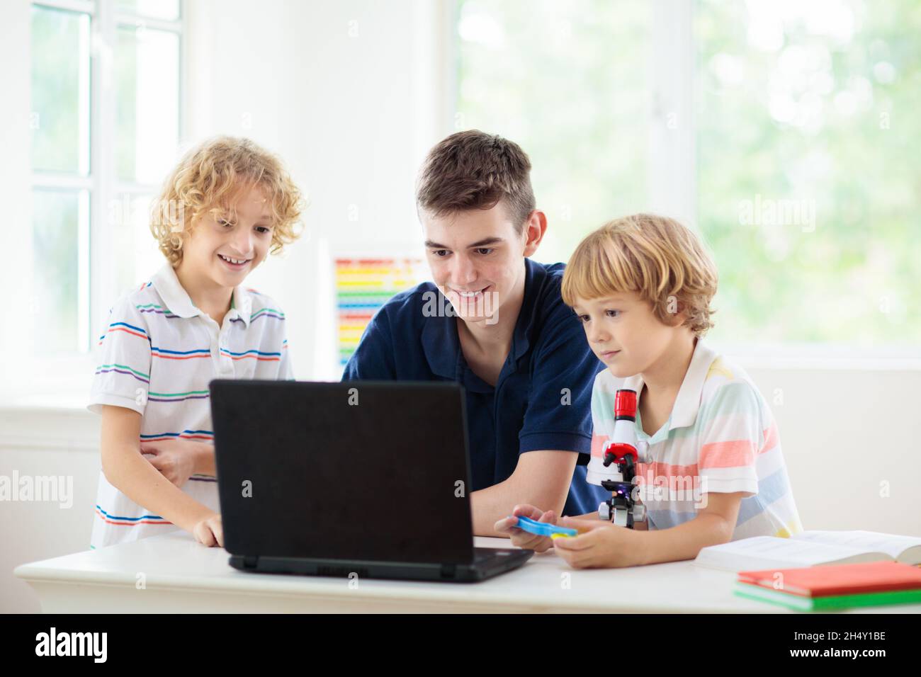 School kids with microscope. Science class. Children making biology or ...