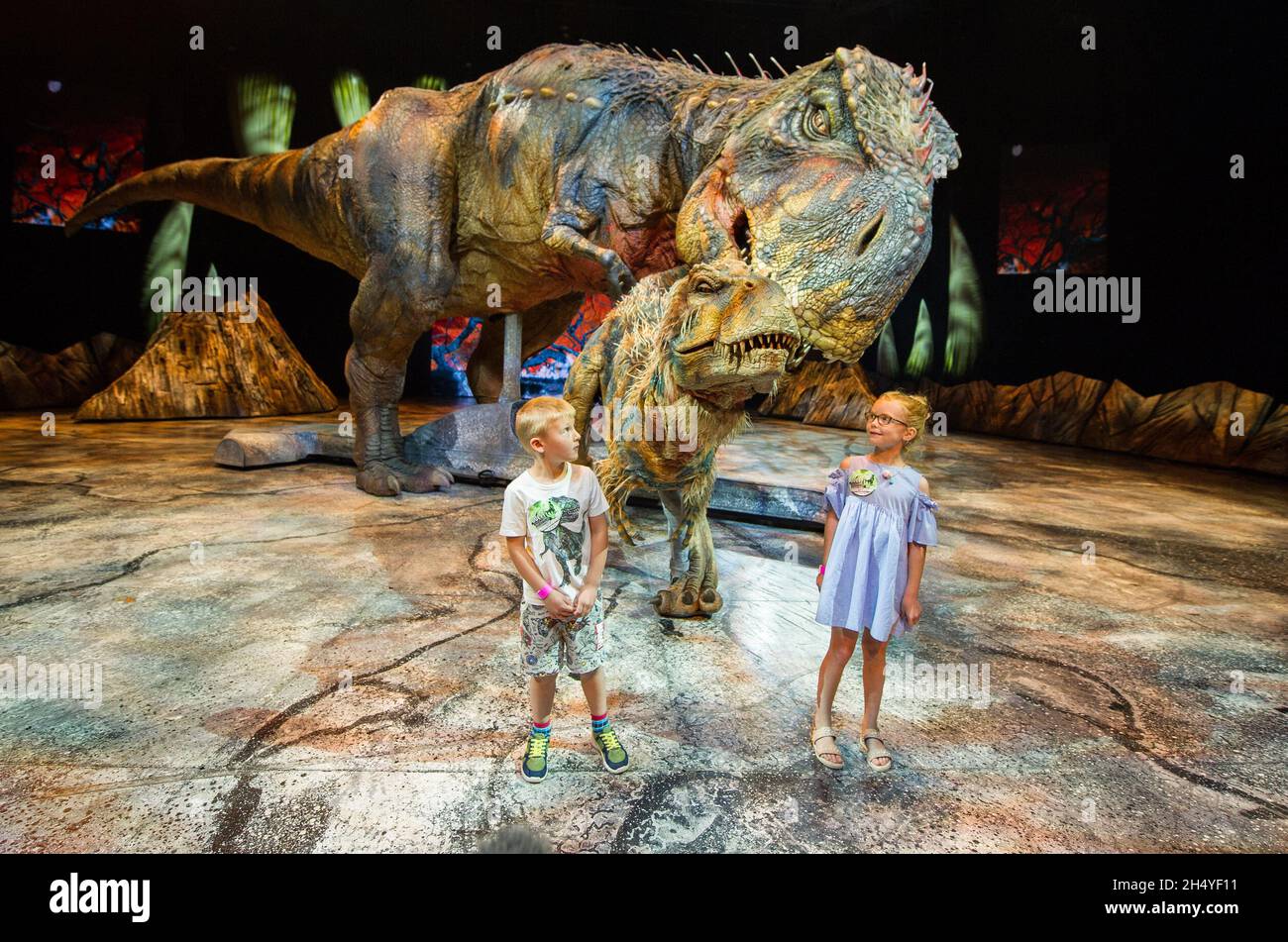 T-Rex and baby T-Rex pose with children during photocall for Walking ...
