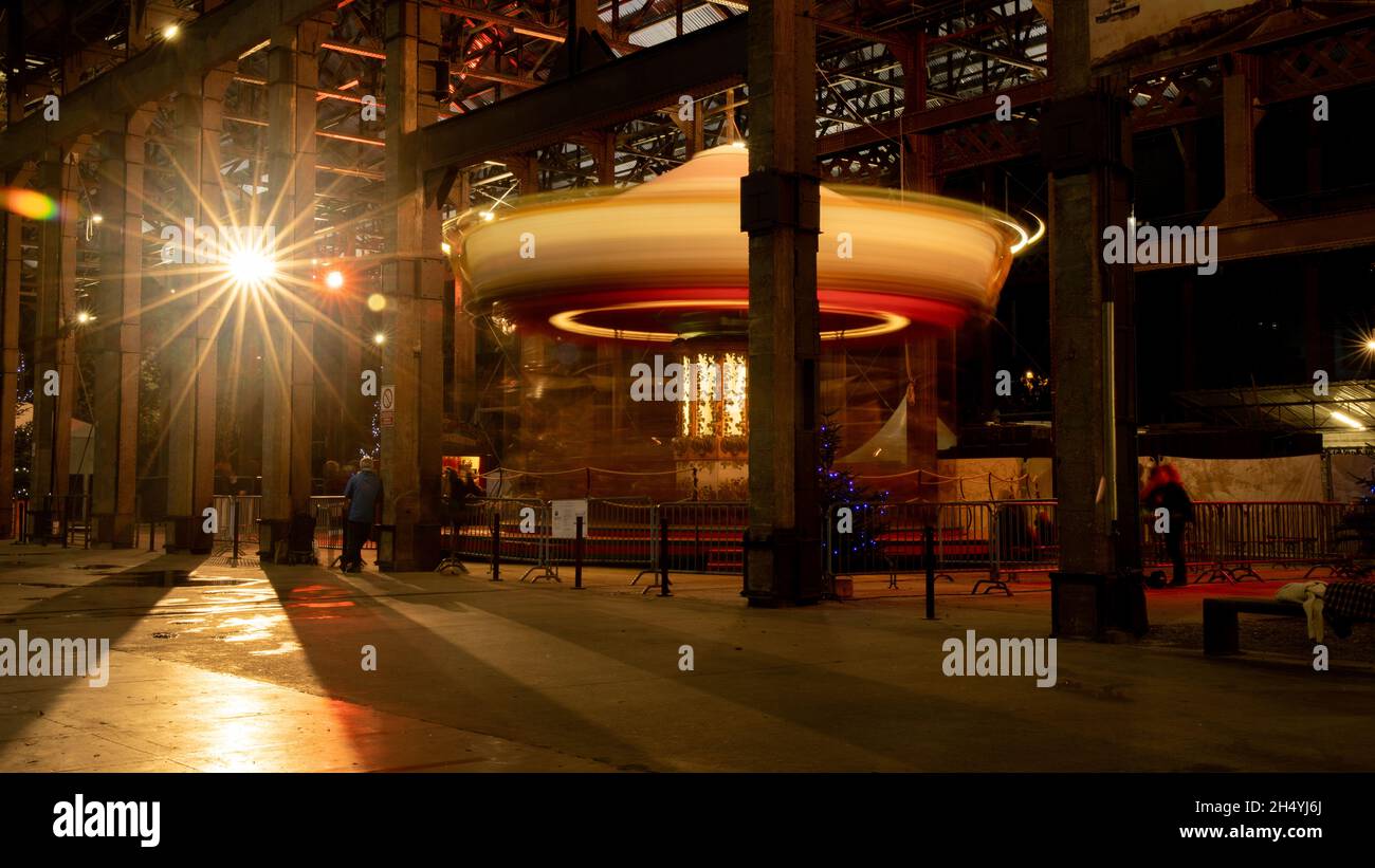 Round abstract object hanging from the celling in the city at night ...