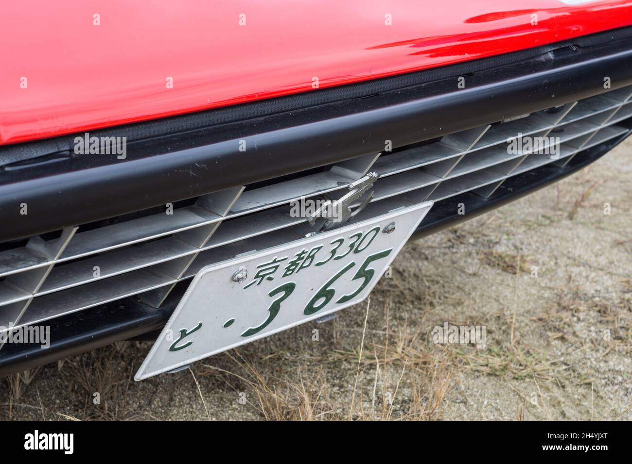 Close up detail of the front grille and number plate on a red 1970s ...