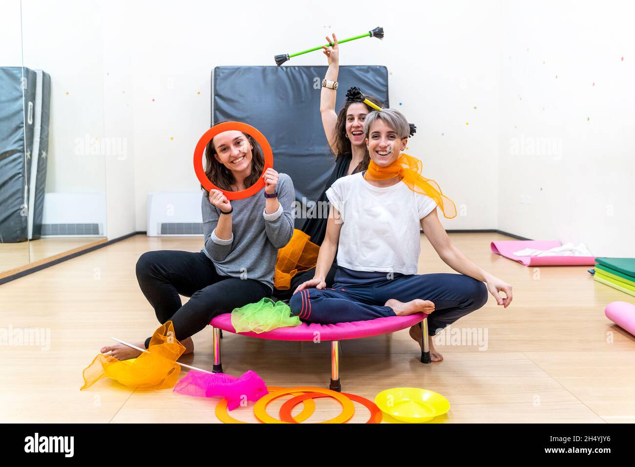 group of millennial female athletes training by performing synchronized ...