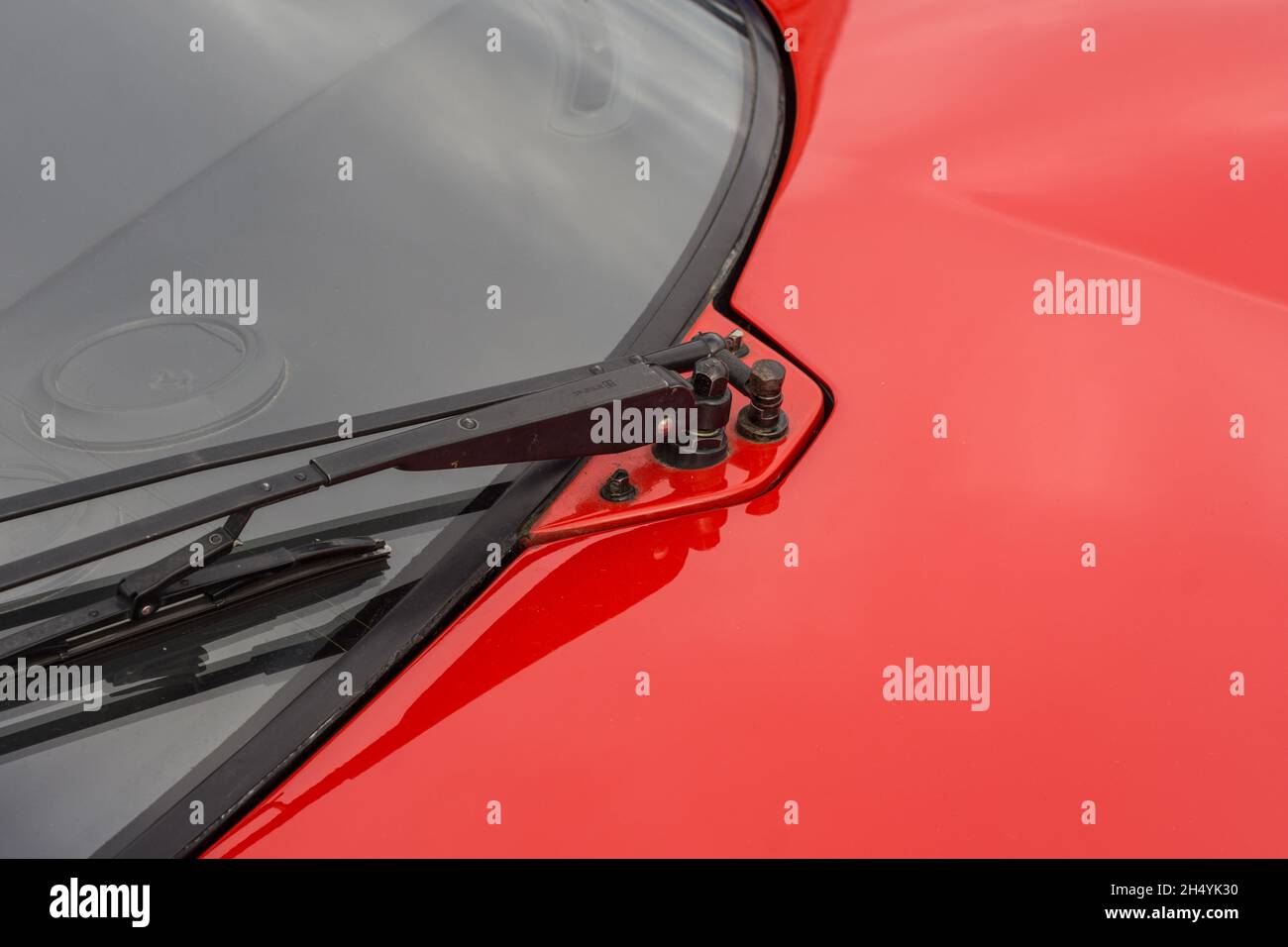 Close up detail of the windscreen wiper and bonnet on a red 1970s ...