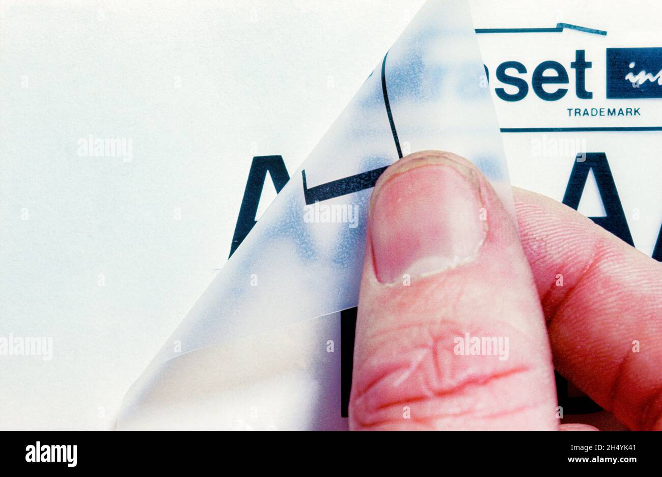 Graphic designer using Letraset, dry transfer lettering system in the ...