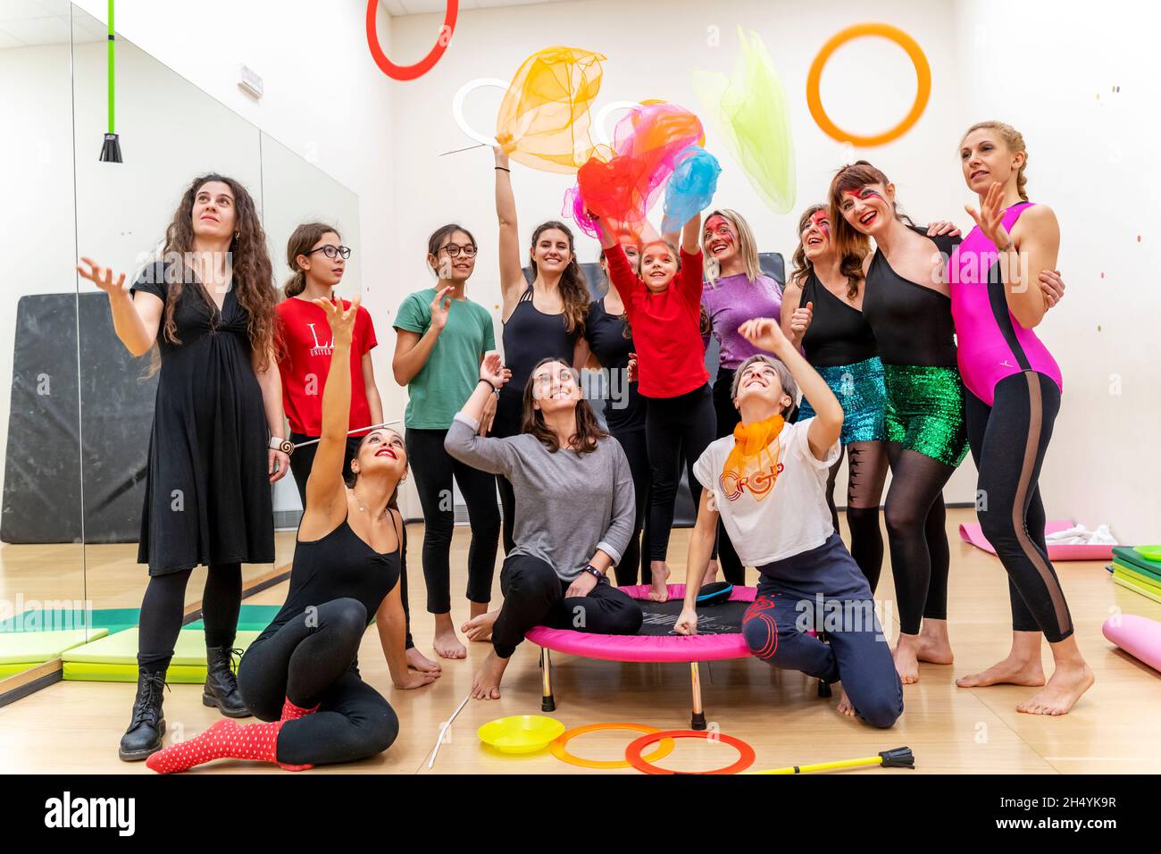 group of female dancers have fun in the gym throwing accessories up ...