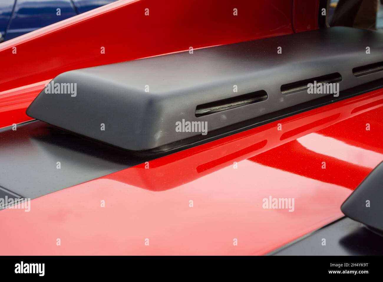 Close up detail of the engine deck cover on the rear of a red 1970s ...