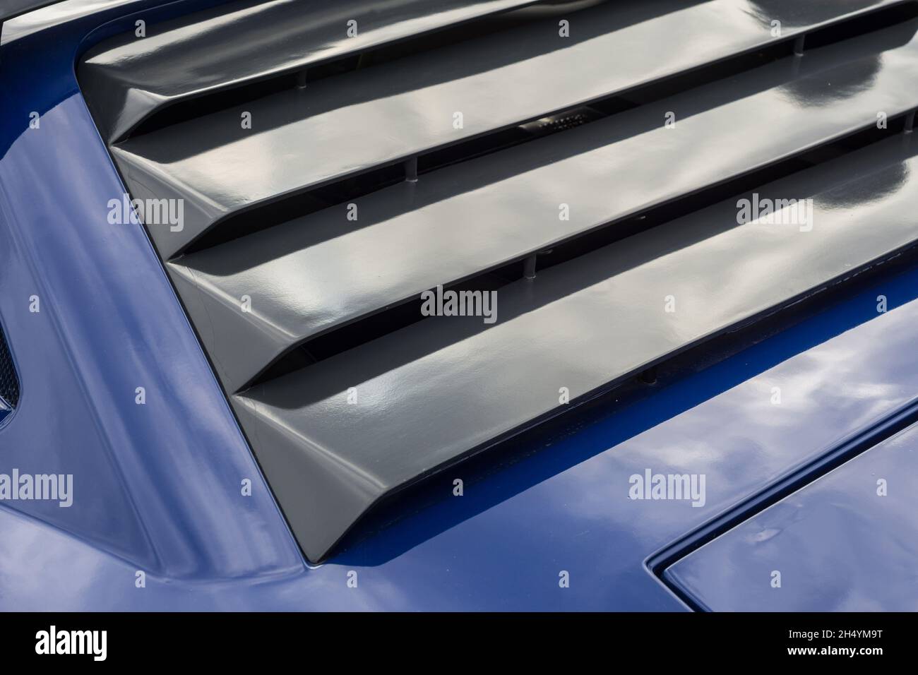 Close up detail of the slatted rear window cover on a blue Lancia ...