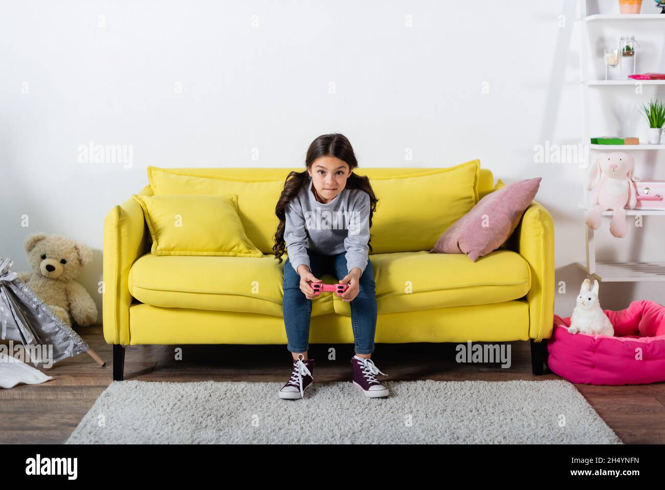 KYIV, UKRAINE - SEPTEMBER 17, 2021: tensed preteen kid playing video ...