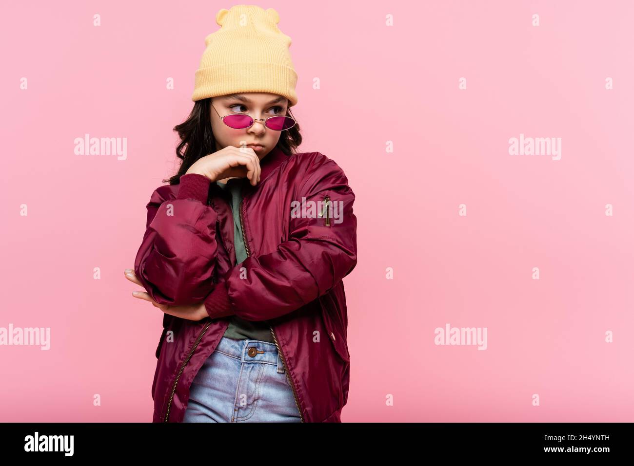 preteen girl in trendy outfit and sunglasses looking away isolated on ...