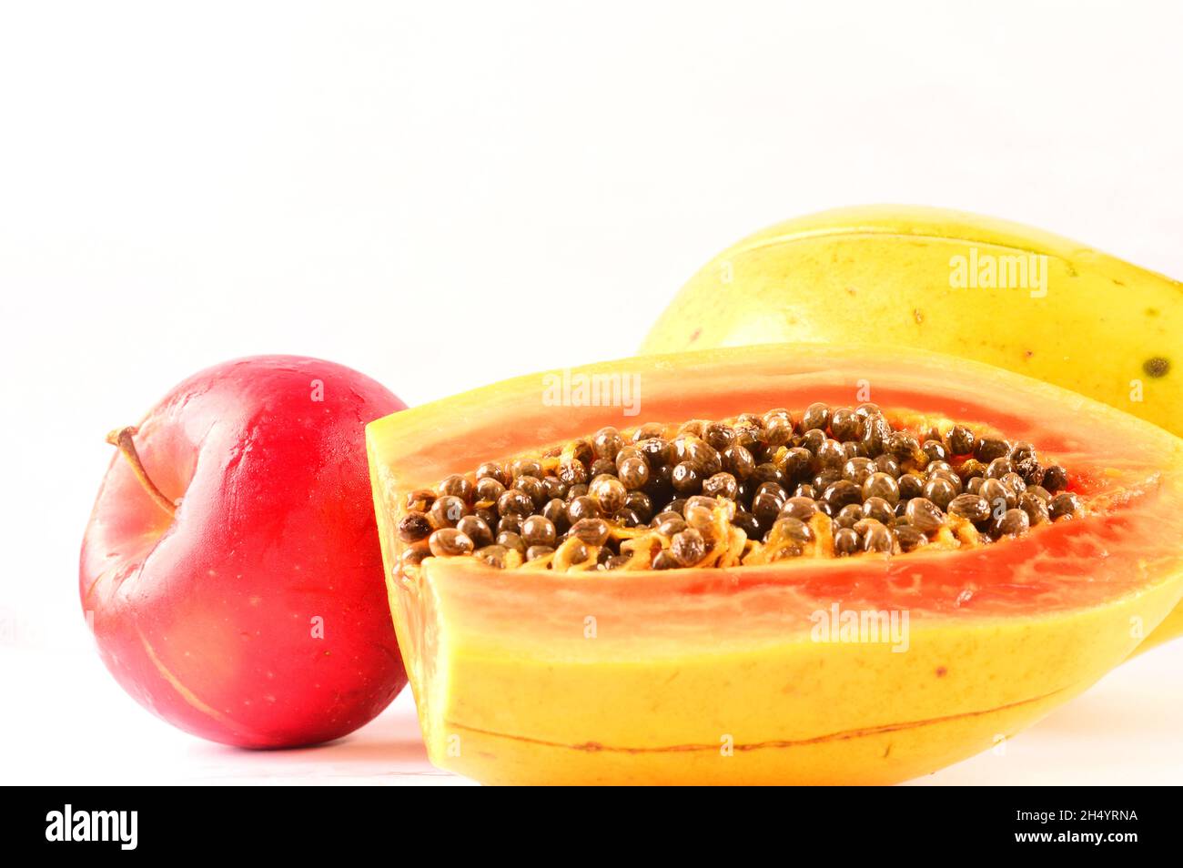 Apple and Papaya seeds on a sliced fruit on white background Stock ...