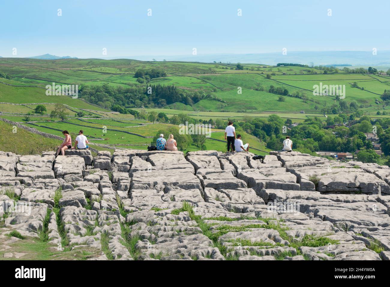 Malham Cove Yorkshire, view in summer of people seated near the cliff ...