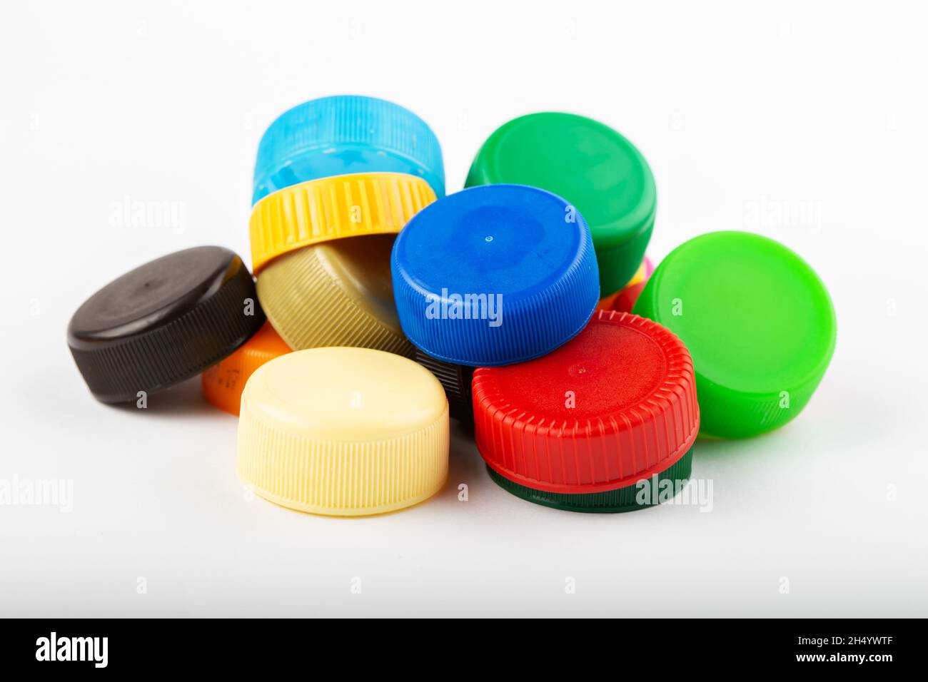 Pile of colored plastic caps on white background. Recycling concept ...