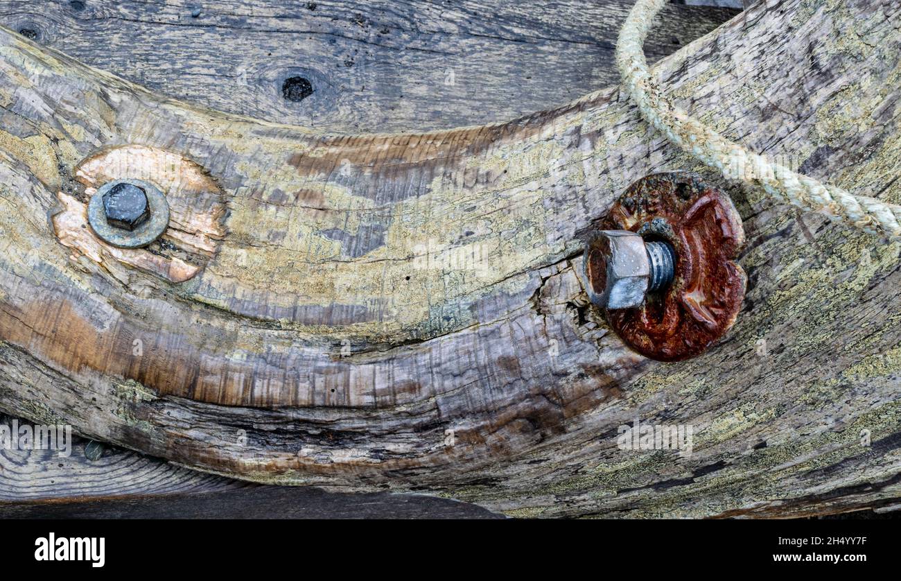 A rustic footbridge is adorned by weathered nautical bolts and rope at ...