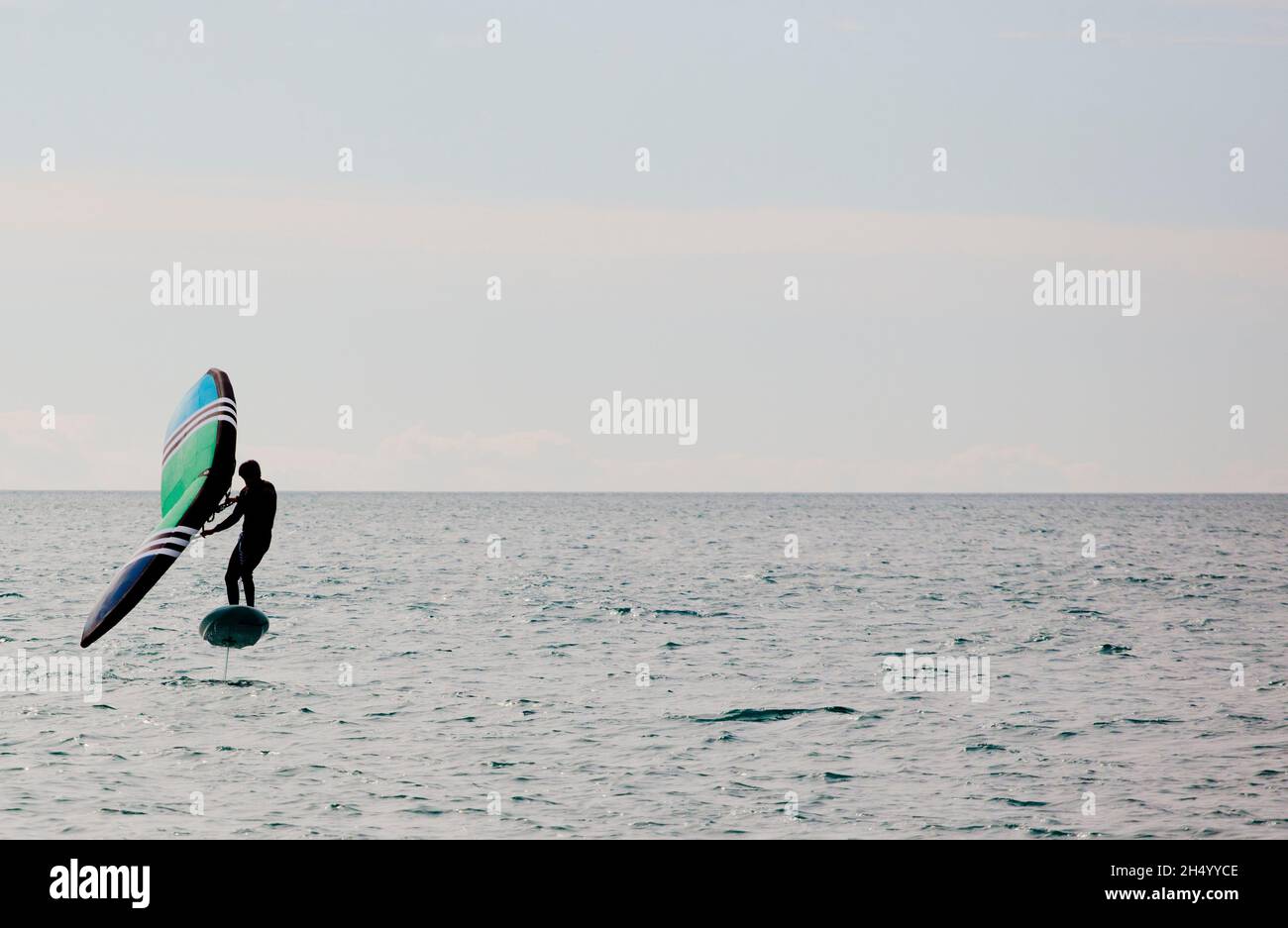 sportsman with wingfoil sailing, in the sea Stock Photo - Alamy