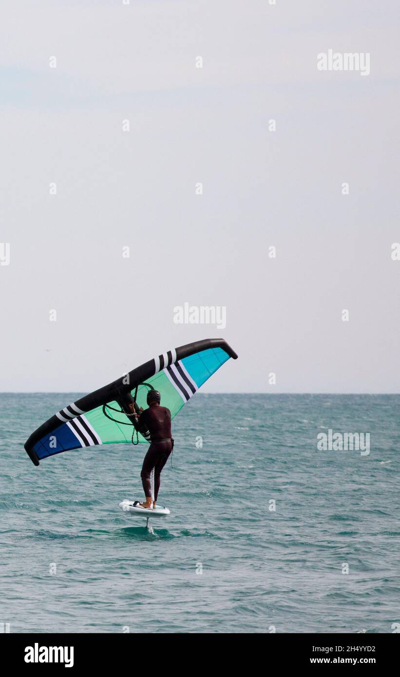 sportsman with wingfoil sailing, in the sea Stock Photo - Alamy