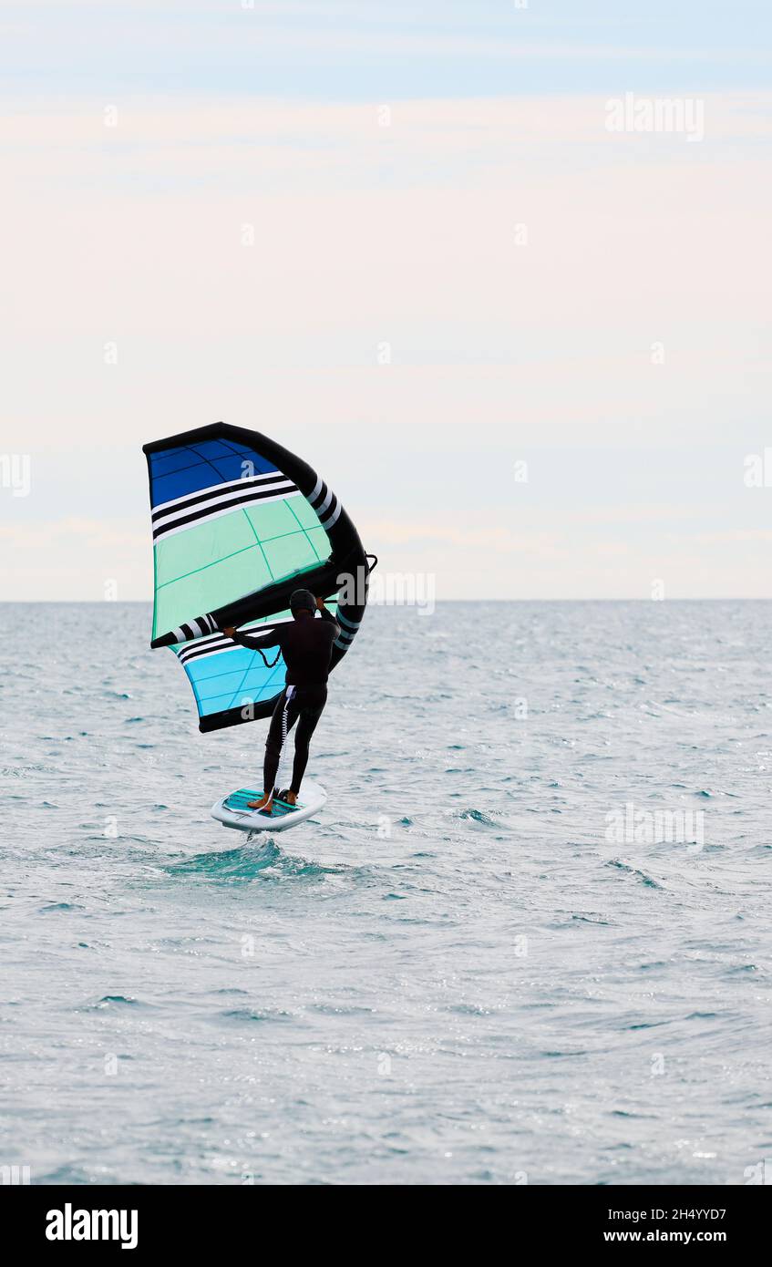 sportsman with wingfoil sailing, in the sea Stock Photo - Alamy