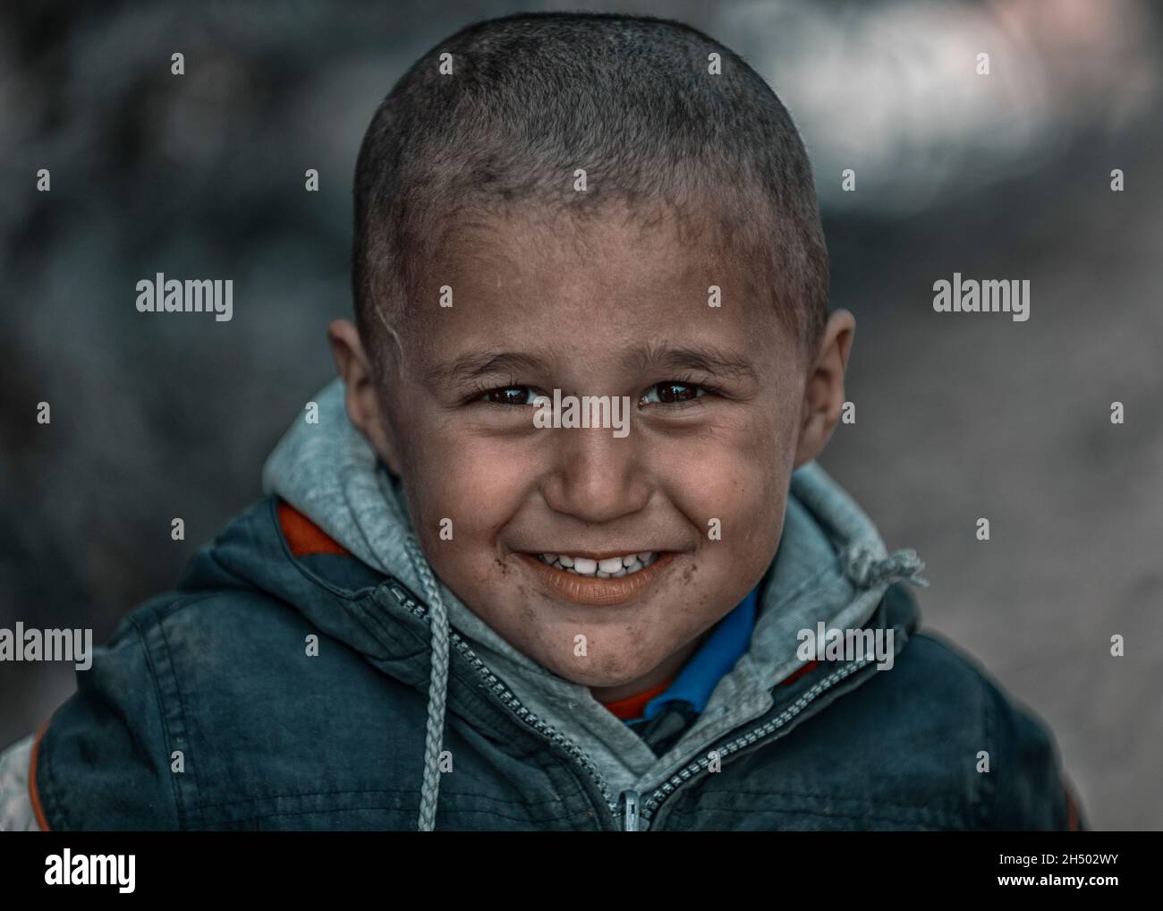 poor child smiles to life Stock Photo - Alamy