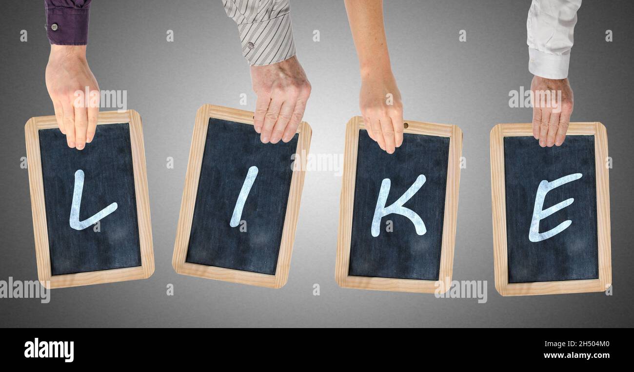 Letters of the word like written on chalkboards held by hands Stock ...