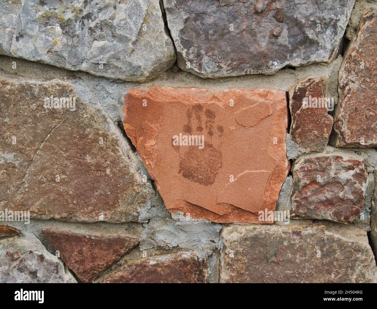 Handprint on a stone of a building outside Stock Photo - Alamy