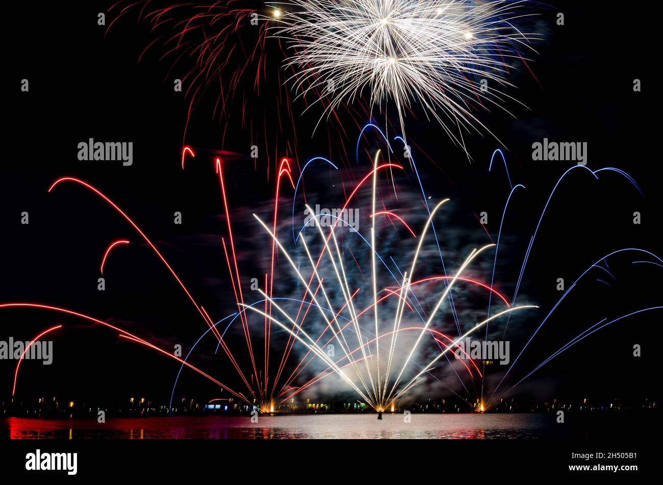 Beautiful fireworks show on a lake Stock Photo - Alamy