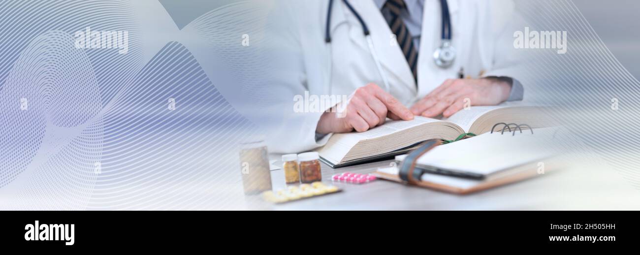 Doctor reading a textbook in medical office; panoramic banner Stock ...
